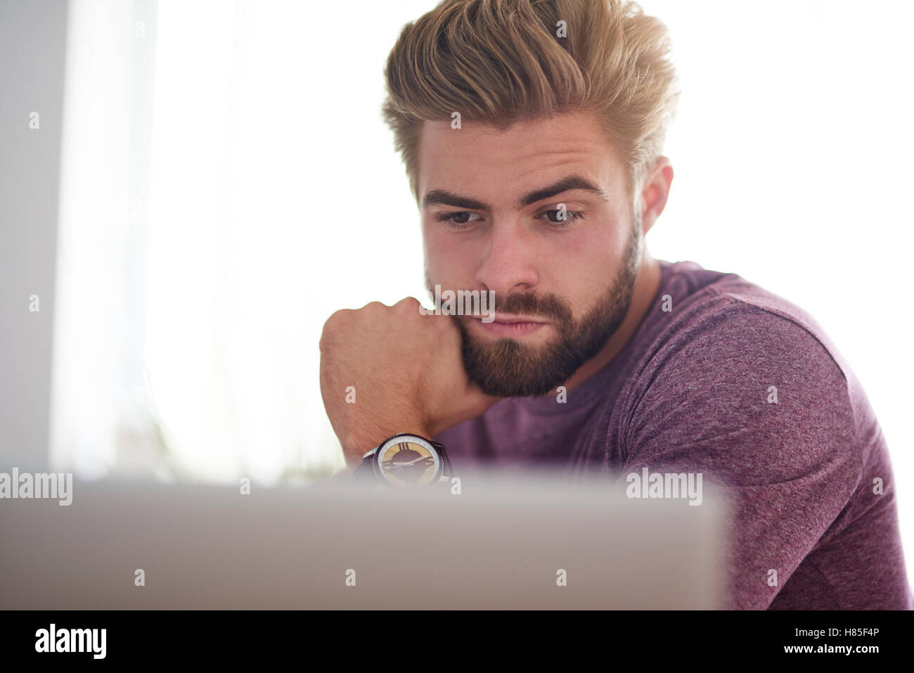 Young man working on computer Stock Photo - Alamy