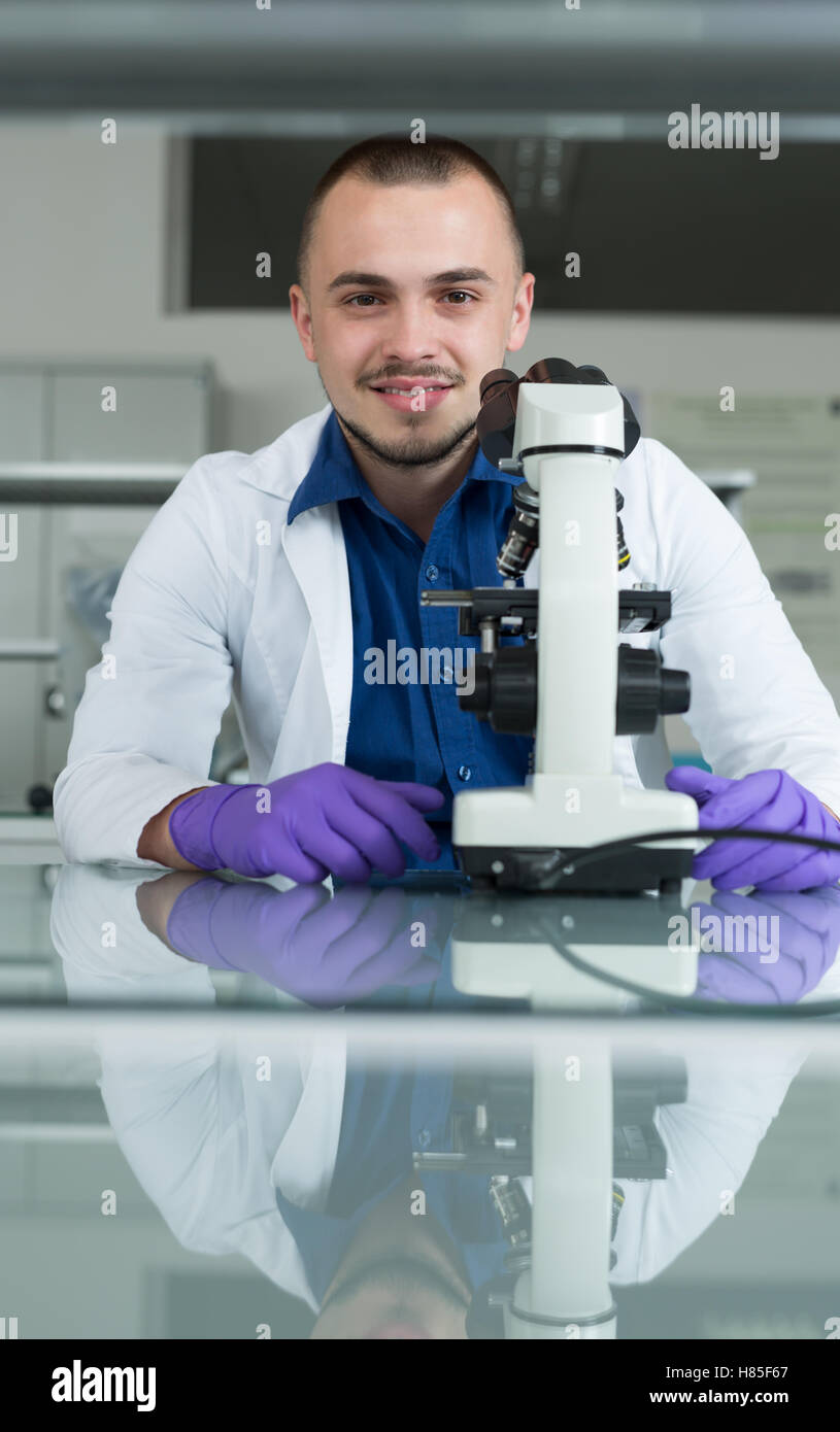 Portrait of caucasian male chemist scientific researcher using ...