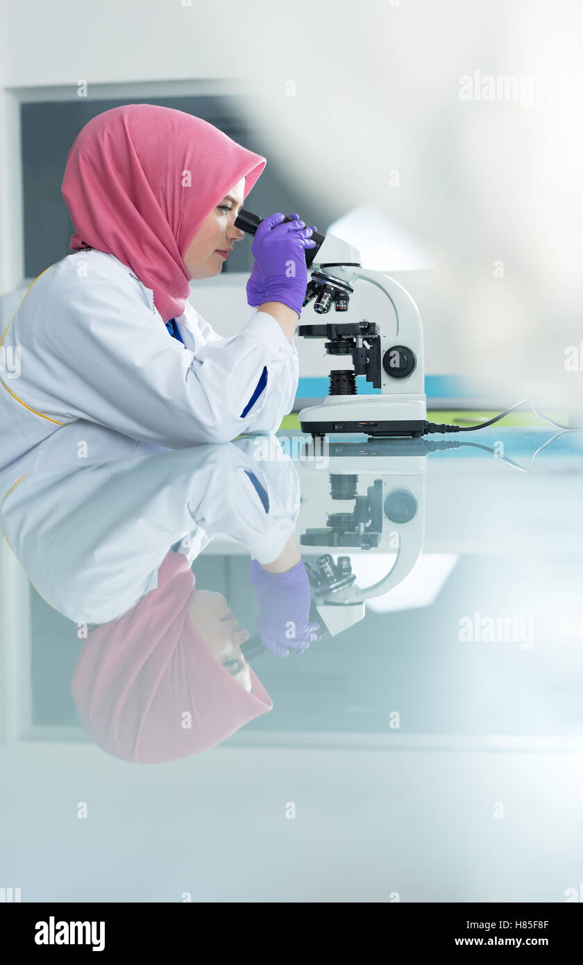 muslim lab worker with hijab or researcher doing an analysis in ...