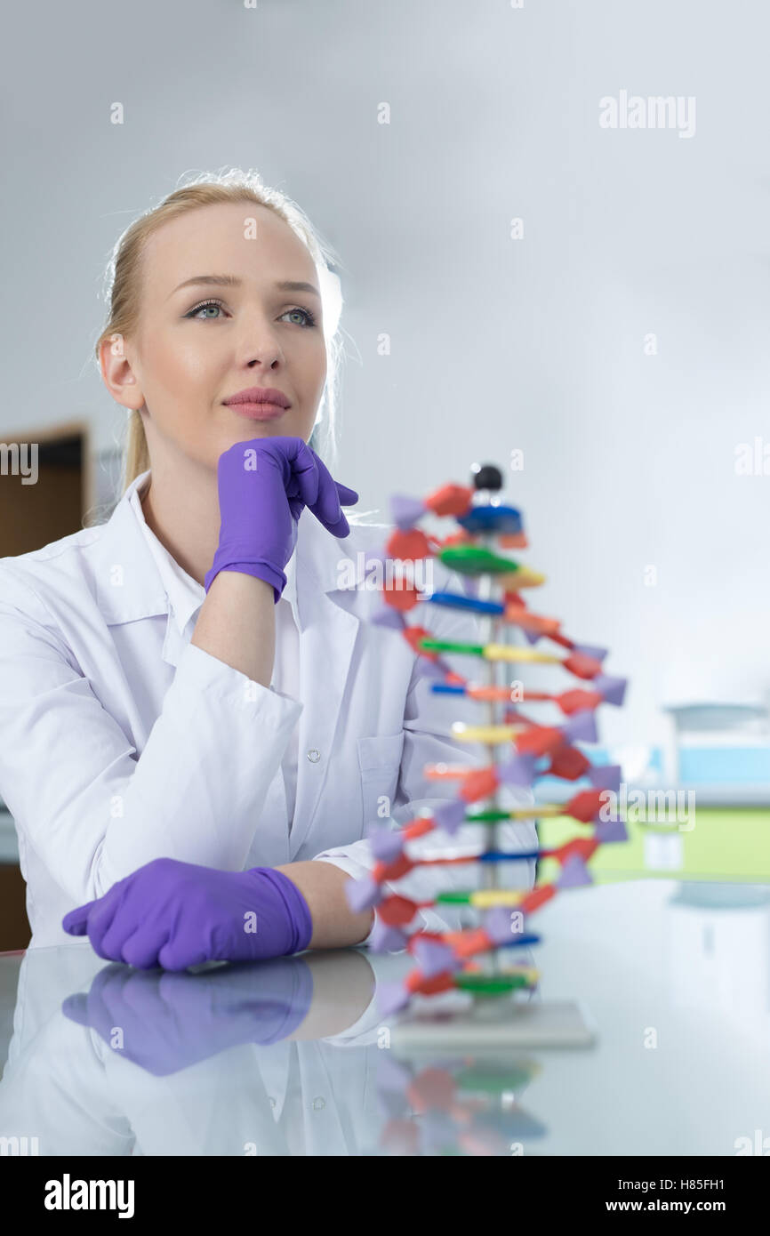 Woman scientist holding DNA molecule Stock Photo - Alamy