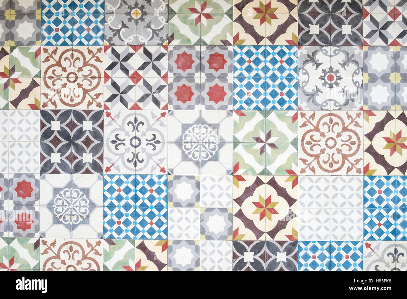 Background of jumble of mismatched tiles with vintage decorative ...