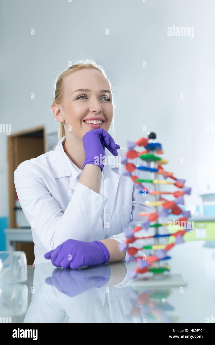 Woman scientist holding DNA molecule Stock Photo - Alamy