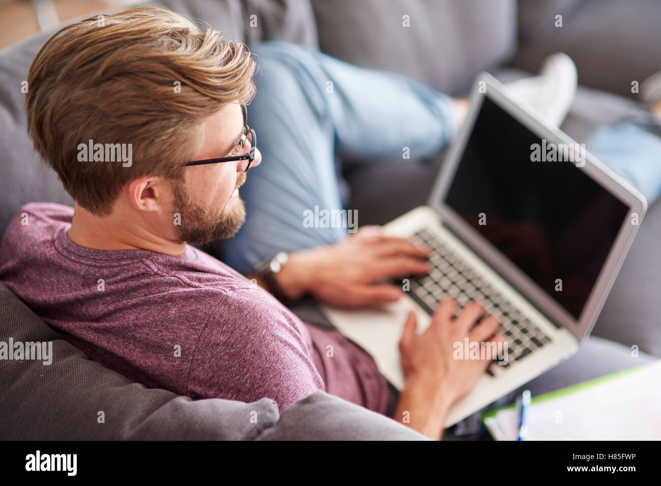 Man working at home with laptop Stock Photo - Alamy