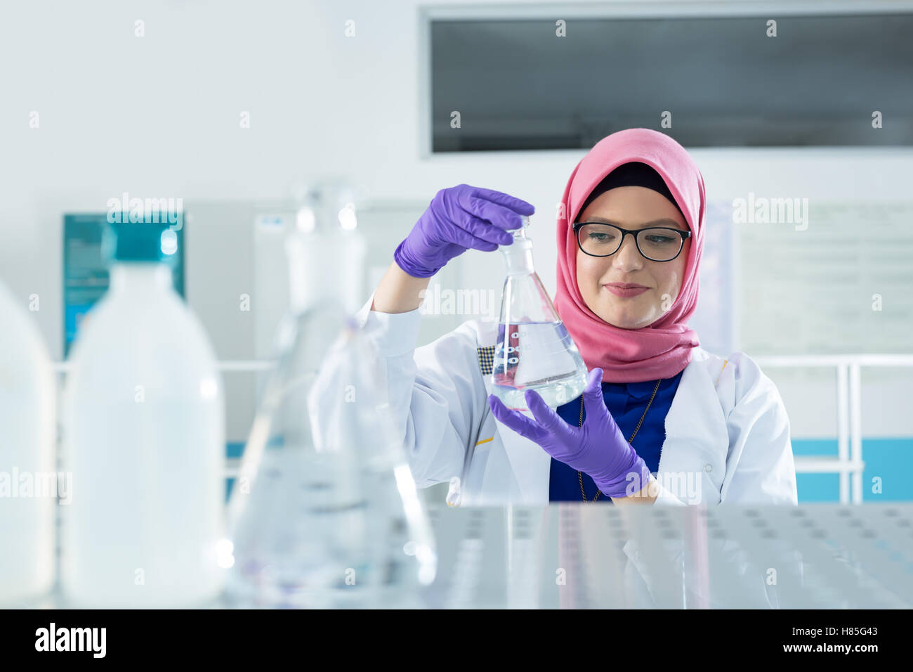 muslim lab worker with hijab or researcher doing an analysis in ...