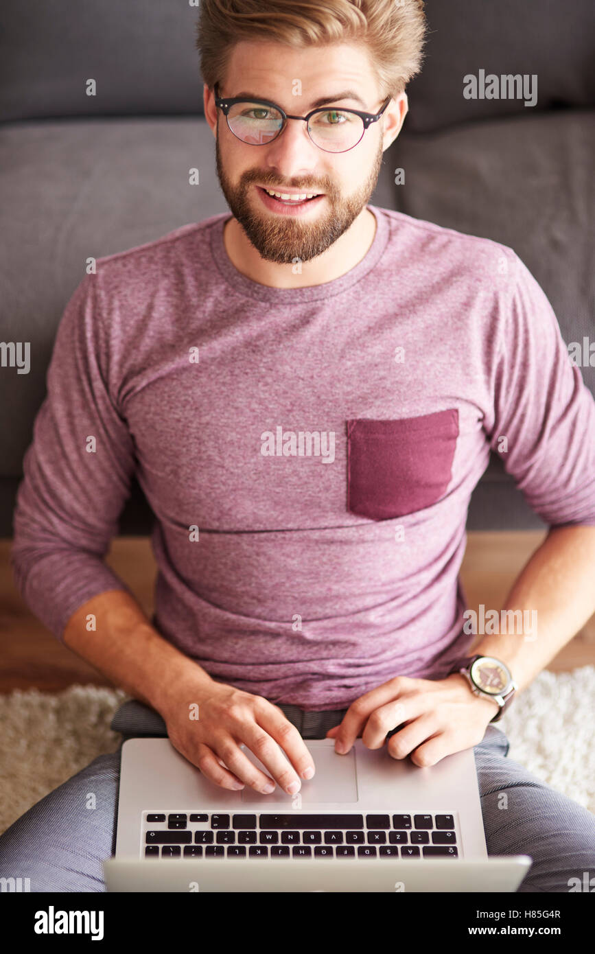 Smiling man with modern laptop Stock Photo - Alamy