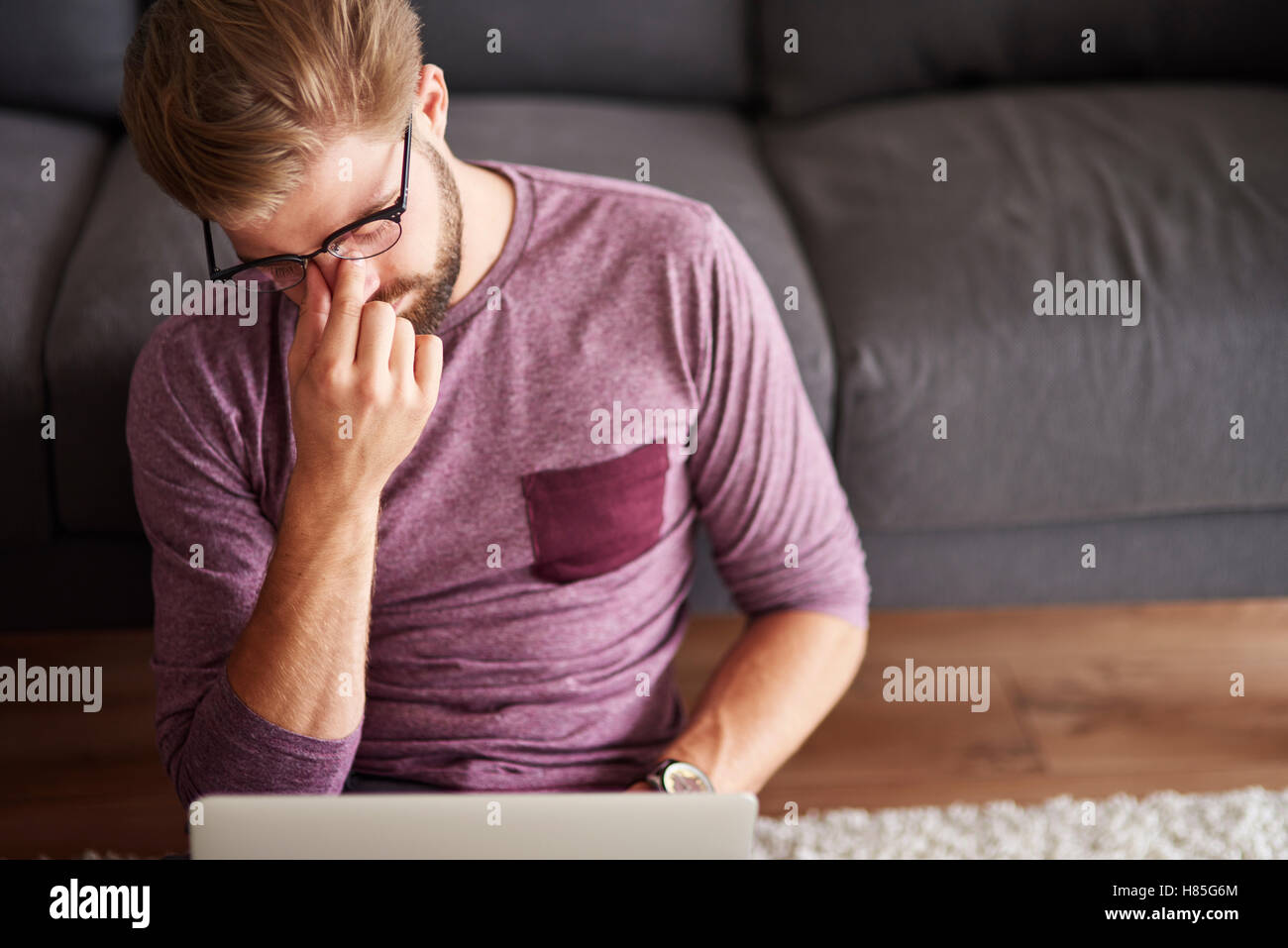 Tired man working at home Stock Photo - Alamy