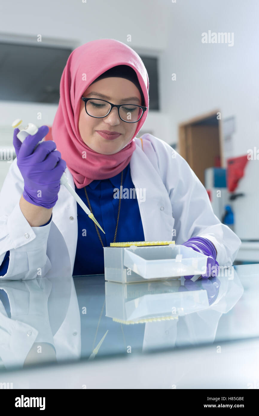 muslim lab worker with hijab or researcher doing an analysis in ...