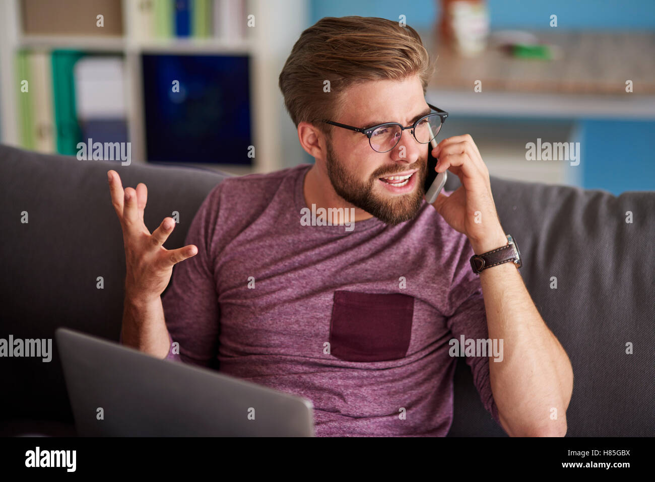 Angry man talking by mobile phone Stock Photo - Alamy