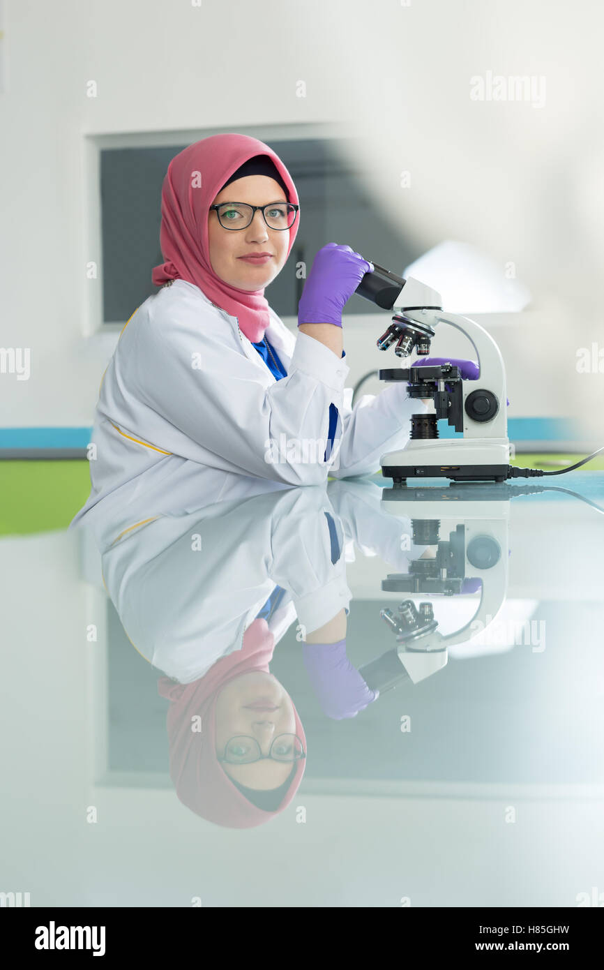 muslim lab worker with hijab or researcher doing an analysis in ...