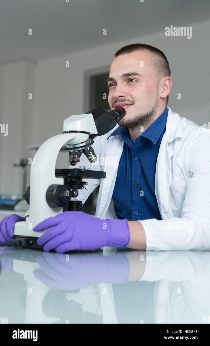 young doctor scientist in bright labaratory work research and analyse ...