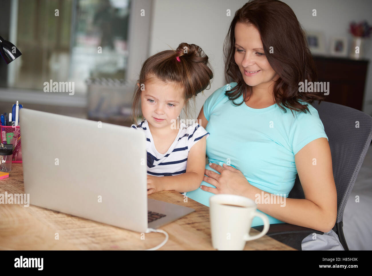 Daughter and mother use technology by computer Stock Photo - Alamy