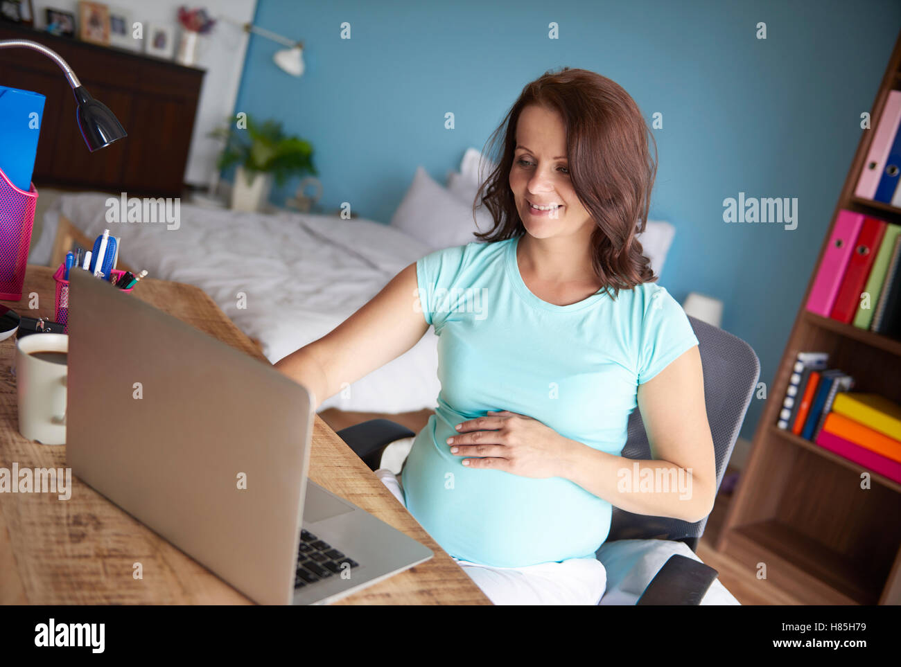 Pregnant women use computer at home Stock Photo - Alamy