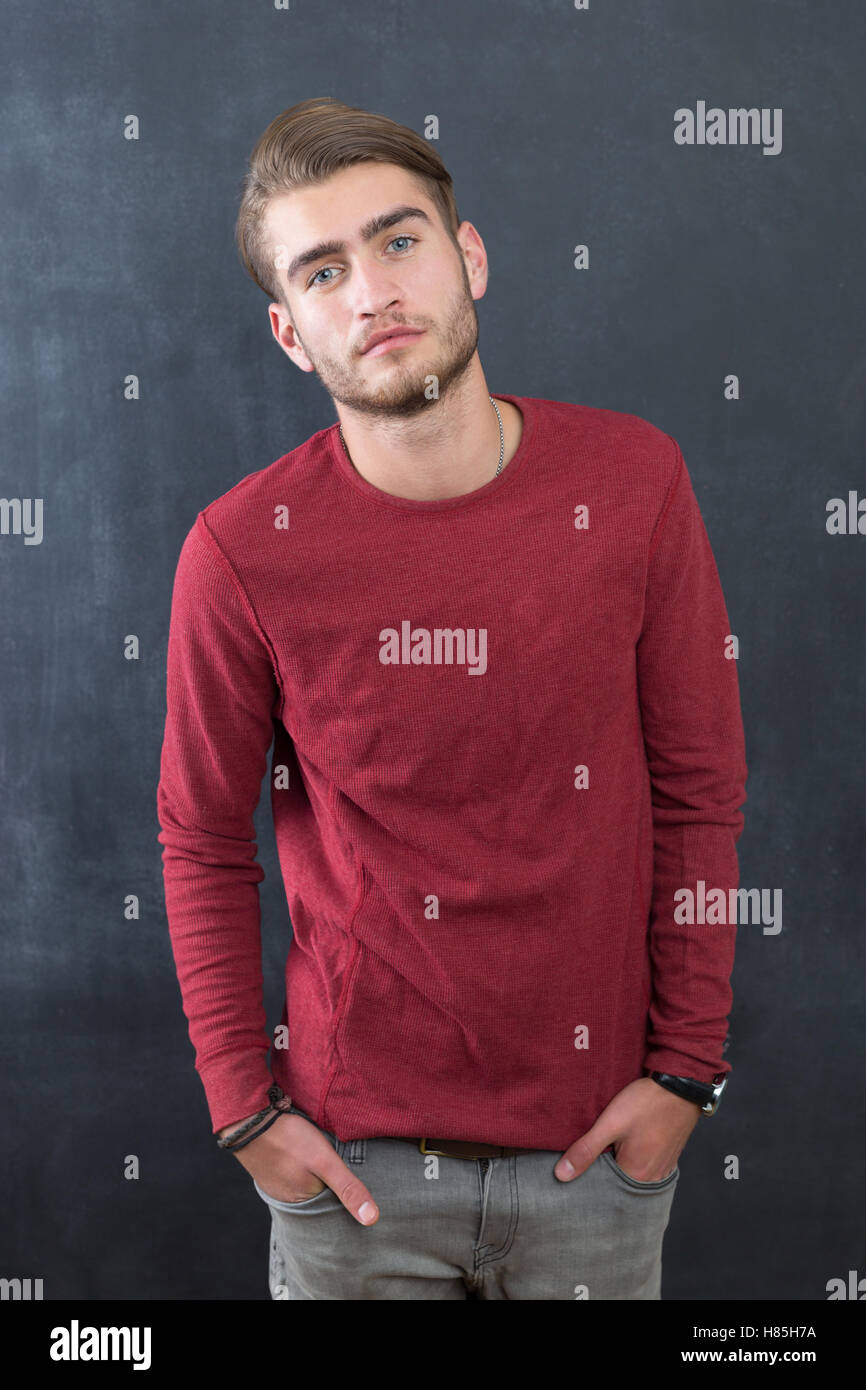 Young man in studio looking at camera Stock Photo - Alamy