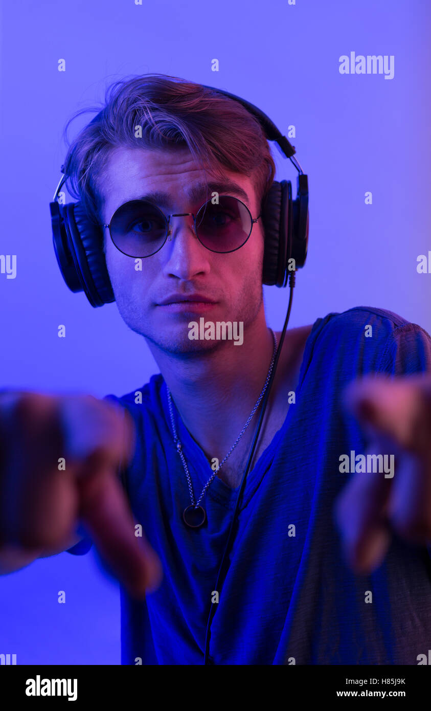 dj with headphones in nightclub party scene, toned image Stock Photo ...