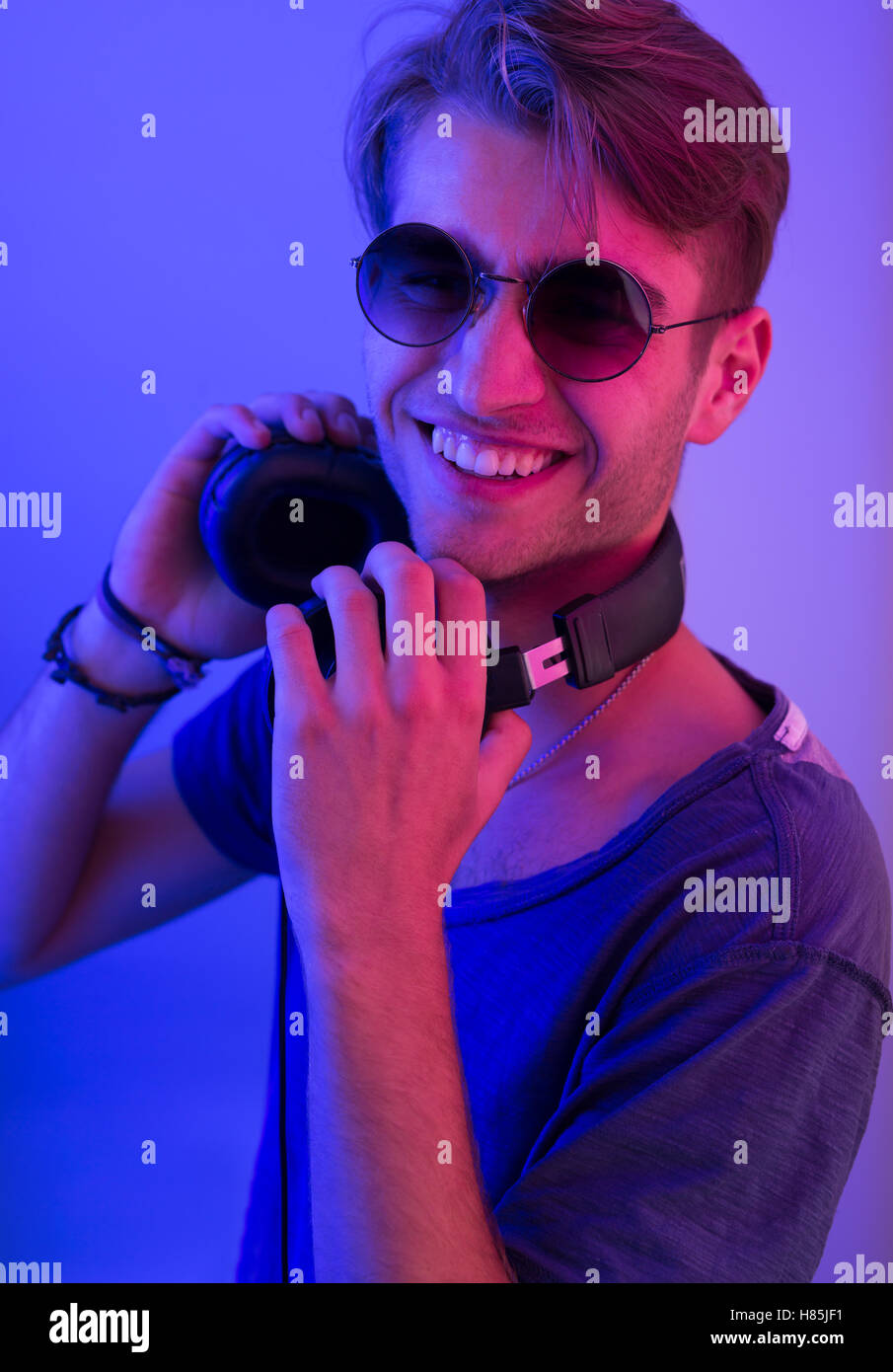 dj with headphones in nightclub party scene, toned image Stock Photo ...
