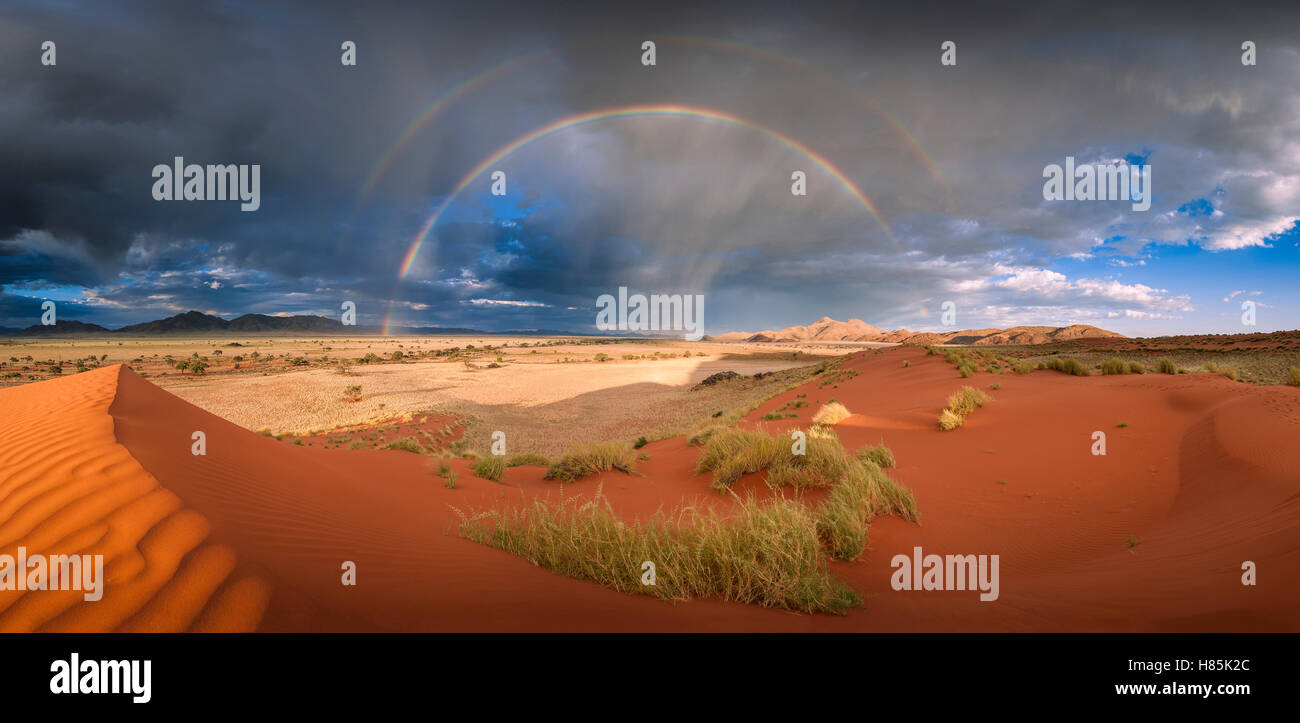 Storm with rainbows over sand dunes, NamibRand Nature Reserve,Namibia ...