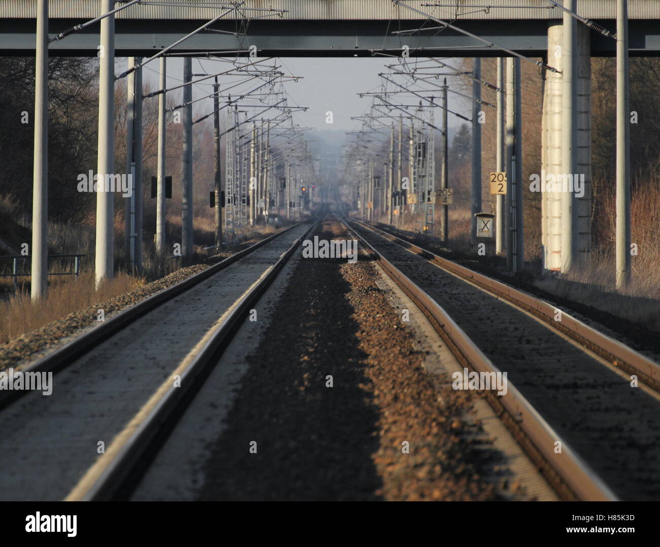 Symmetrical shot from the middle of two rail tracks Stock Photo - Alamy