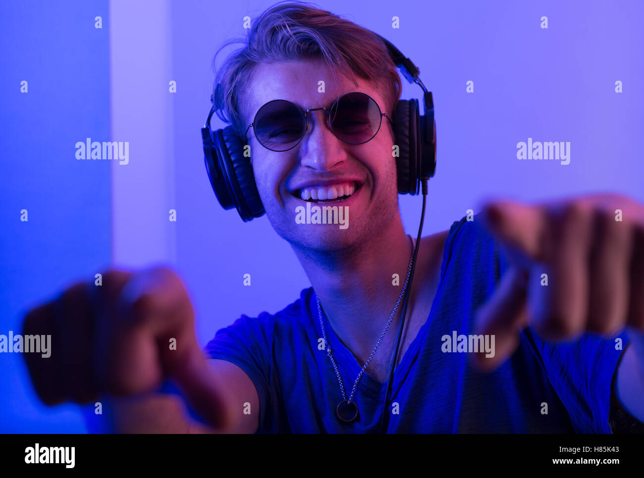 dj with headphones in nightclub party scene, toned image Stock Photo ...