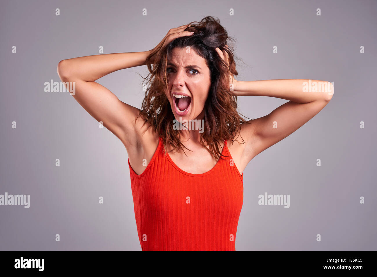 A beautiful young woman screaming furiously Stock Photo - Alamy