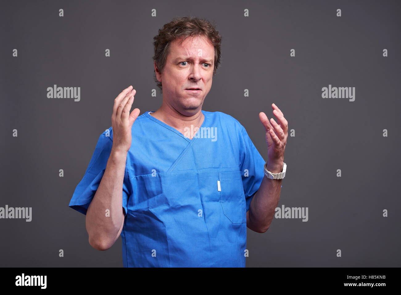 A middle aged male doctor standing and feeling scared Stock Photo - Alamy