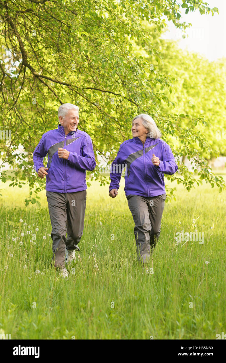 Senior couple jogging in park Stock Photo - Alamy