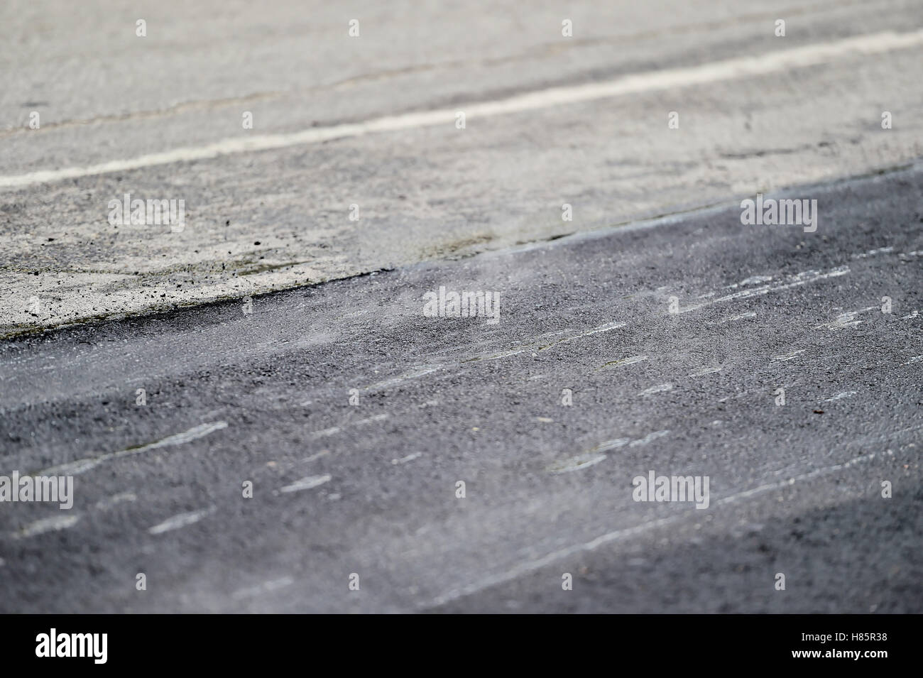 Asphalt paving with a steel wheel roller. Steam coming out from asphalt ...