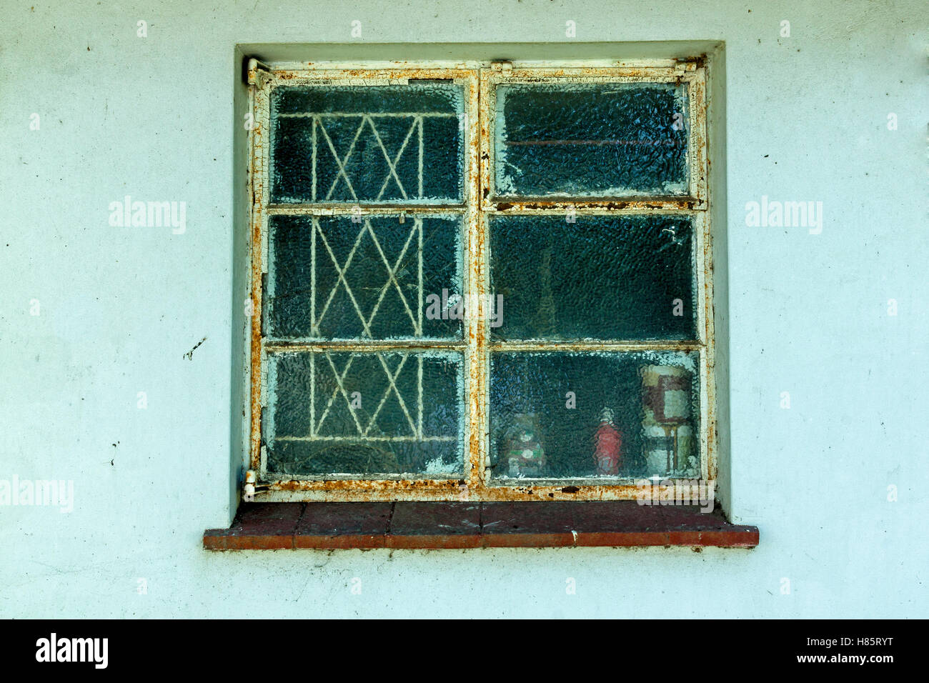 Single rusted neglected window and glass on dirty light blue wall Stock ...