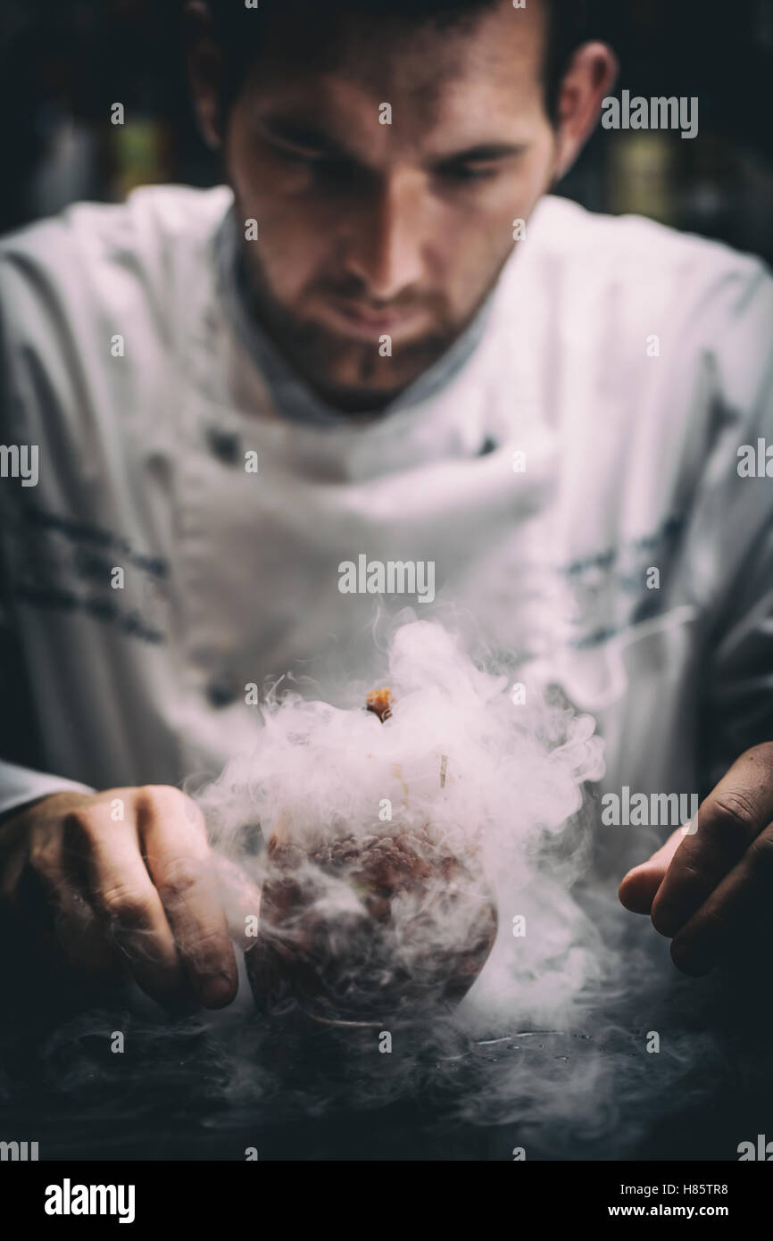 Chef served a gourmet smoking food Stock Photo - Alamy