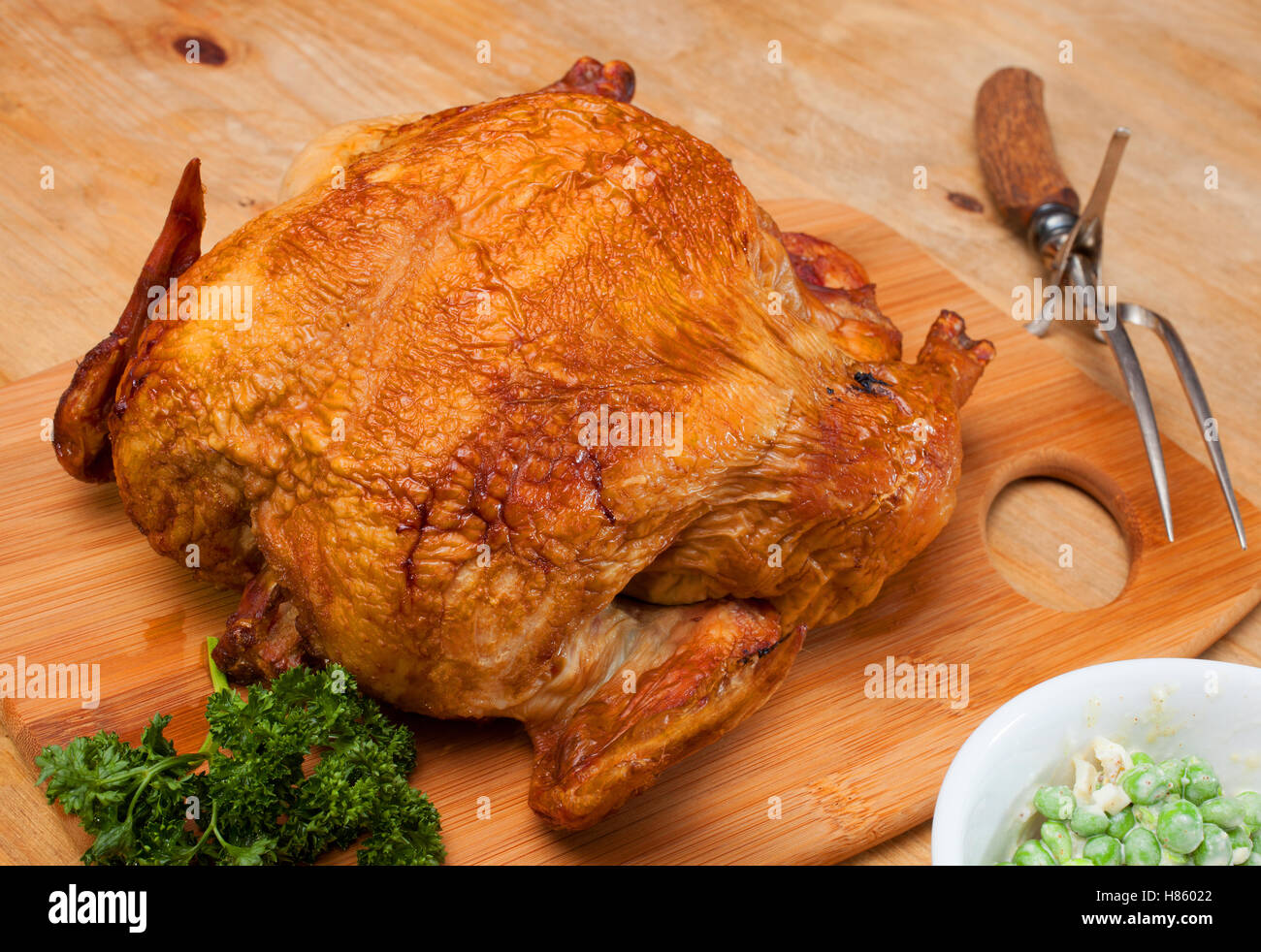 Chicken hen that has been slowly cooked with peas on the side Stock ...