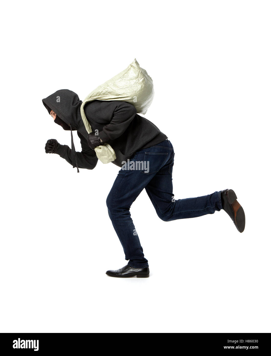 Thief runs with gray bag Stock Photo - Alamy