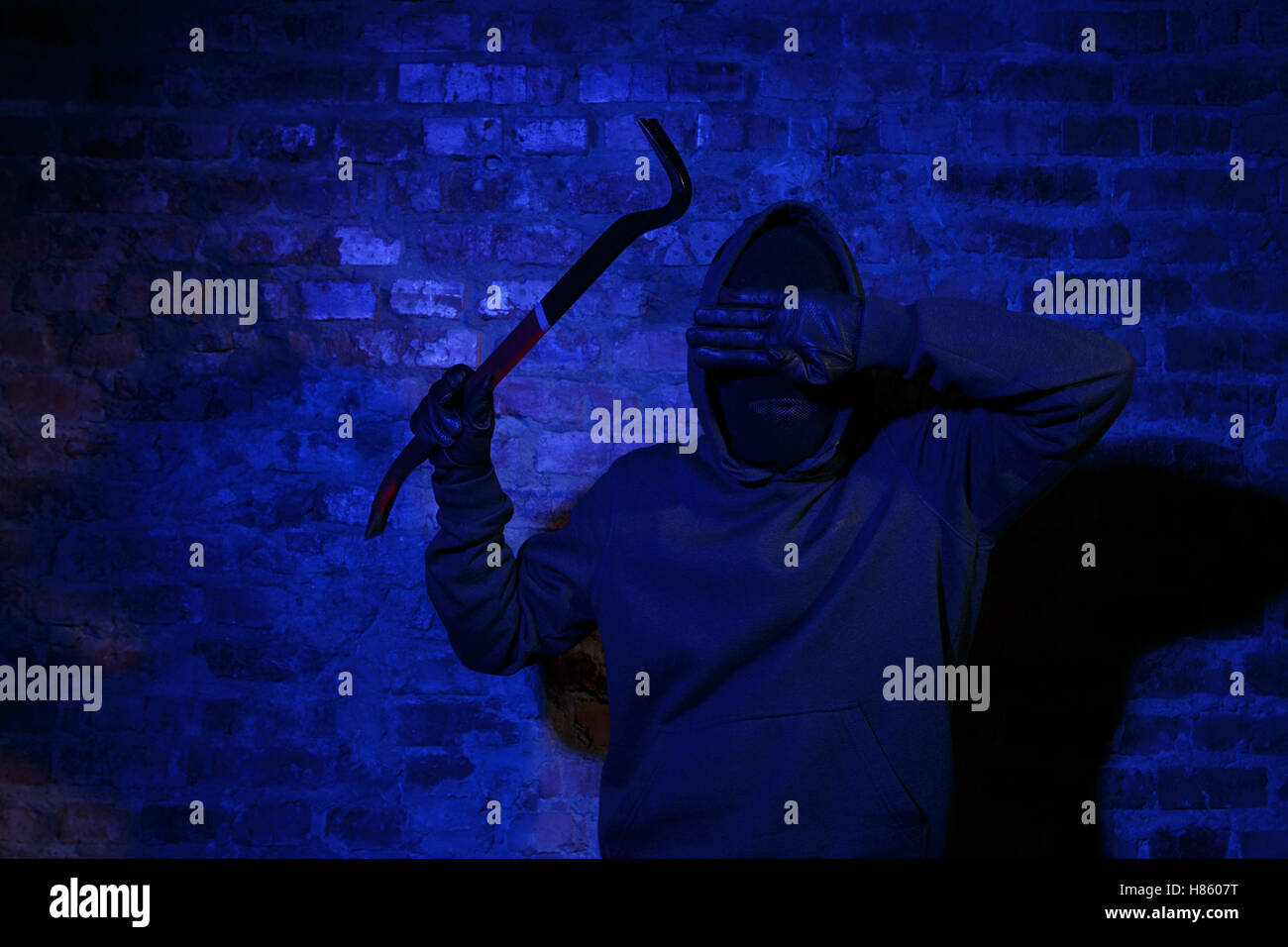 Thief closes eyes with hand Stock Photo - Alamy