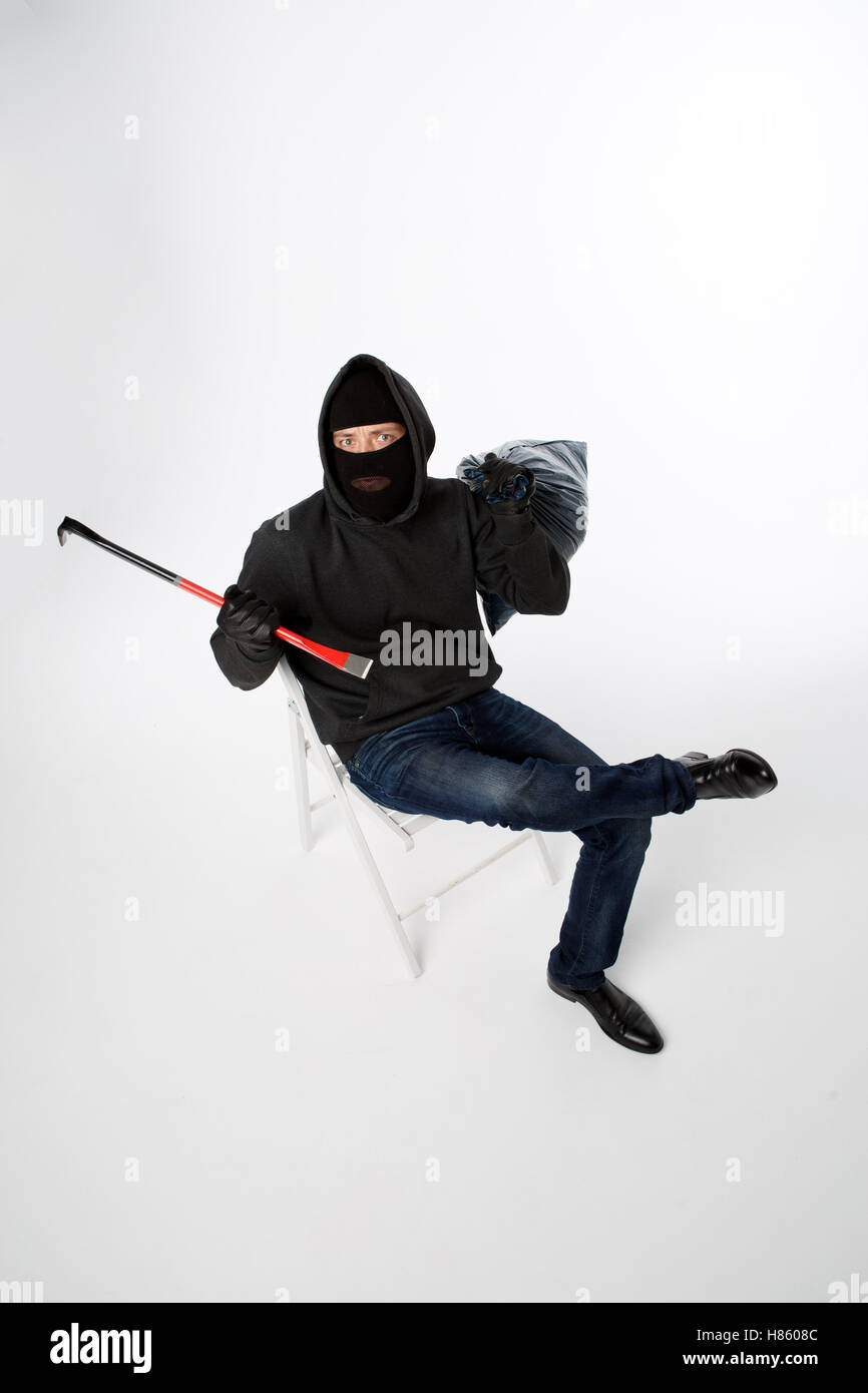 Robber sitting on white chair Stock Photo - Alamy
