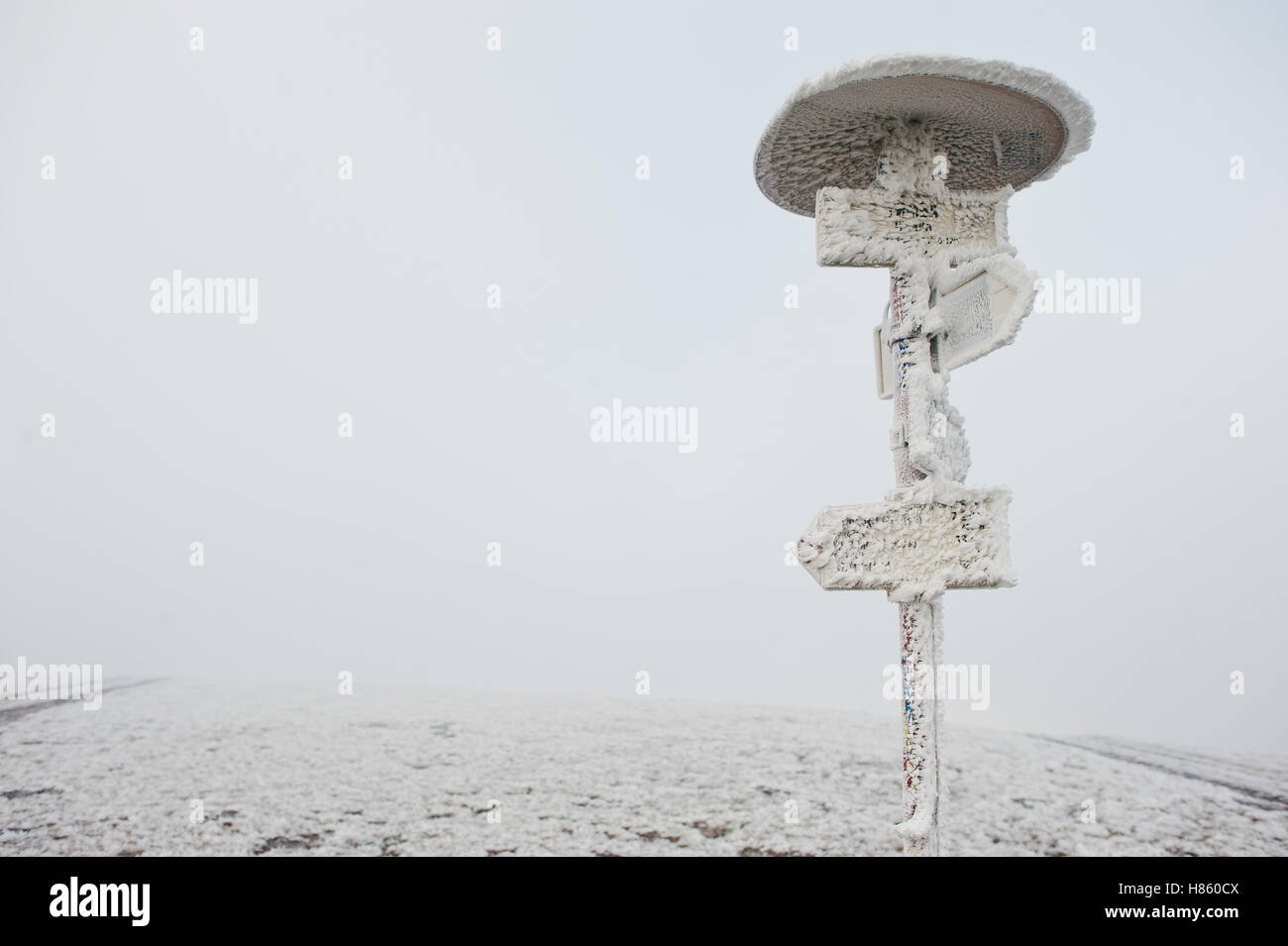 Frozen pointer with directional arrows at mountains Stock Photo - Alamy
