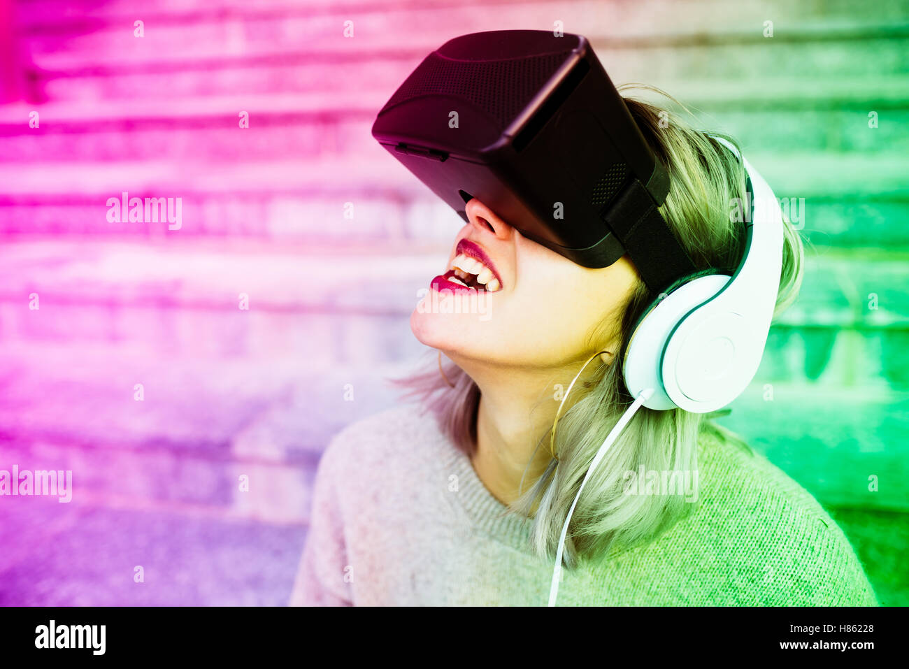 Portrait of young beautiful caucasian purple grey hair woman using 3D ...