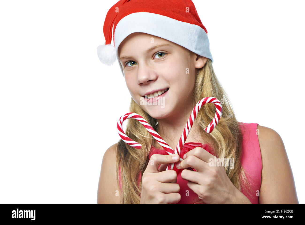 Girl in red cap with christmas candy canes isolated white Stock Photo ...
