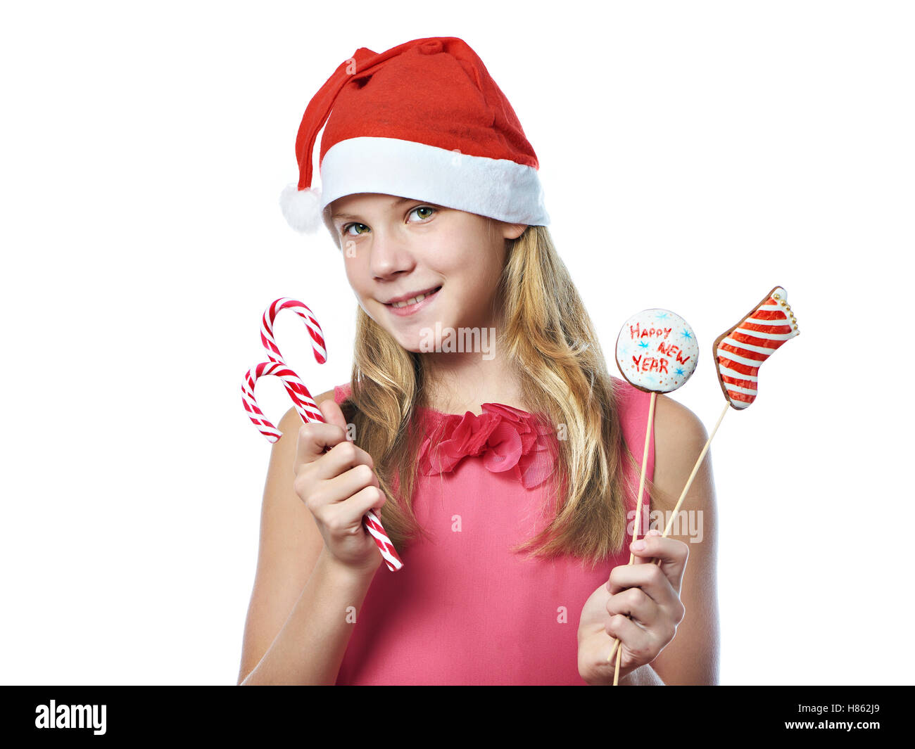 Happy teen girl in red cap with Christmas candy isolated white Stock ...