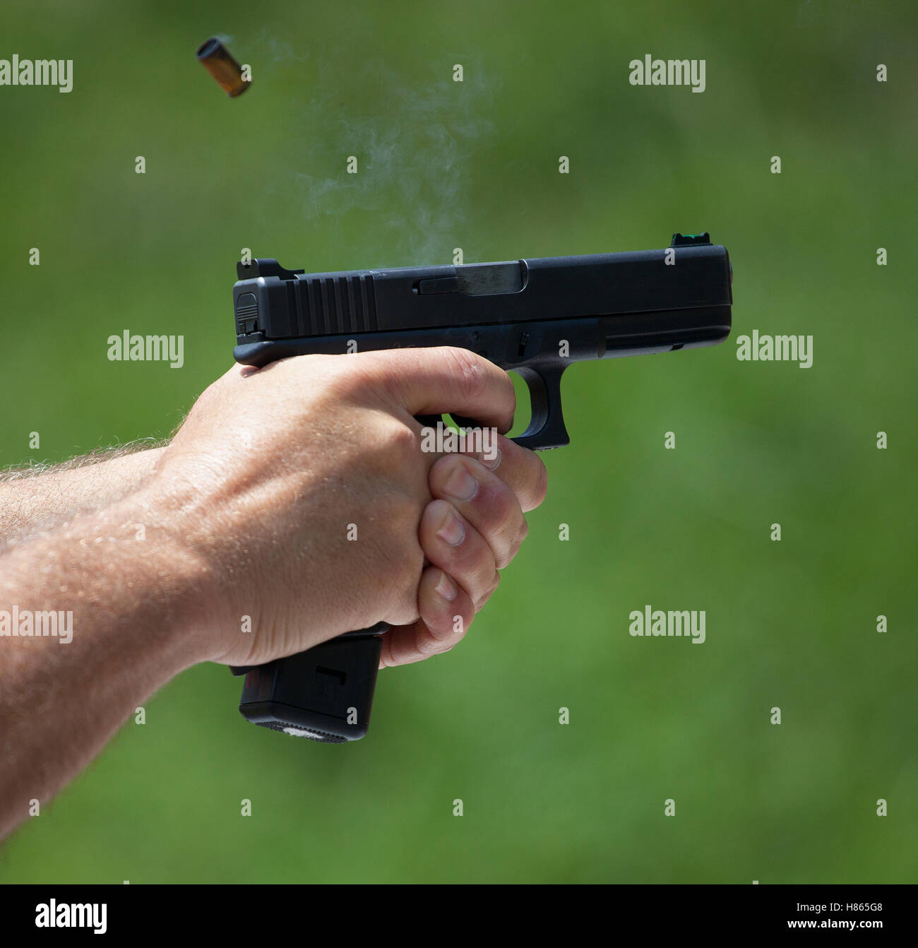 Polymer handgun a split second after the shot Stock Photo - Alamy
