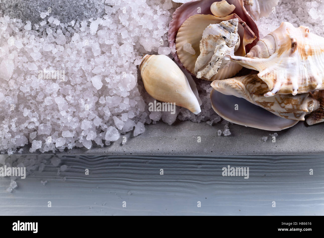 Sea salt with stones and shells on wooden table Stock Photo - Alamy