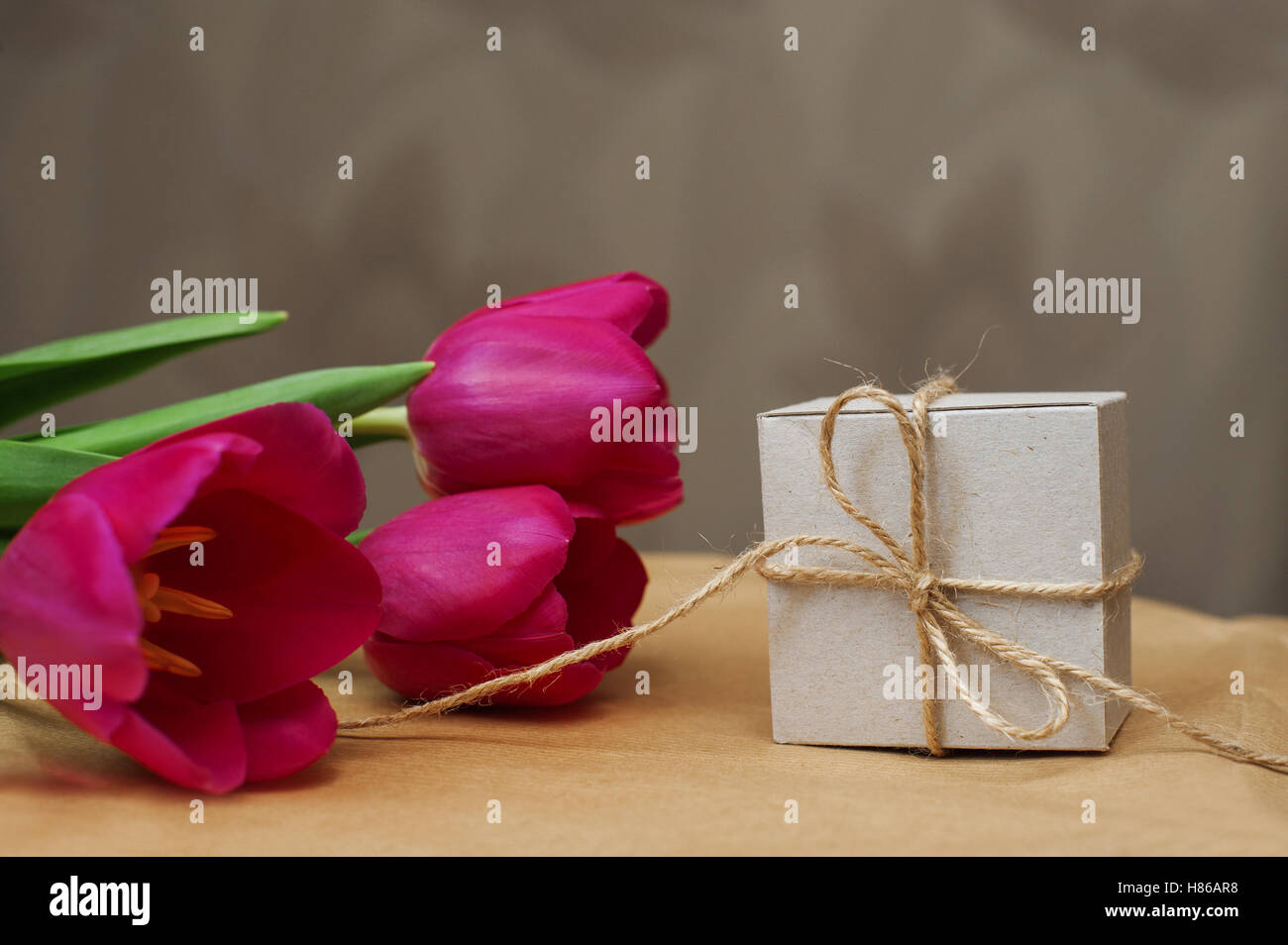Purple tulip bouquet and gift box on wooden table with copy space Stock ...