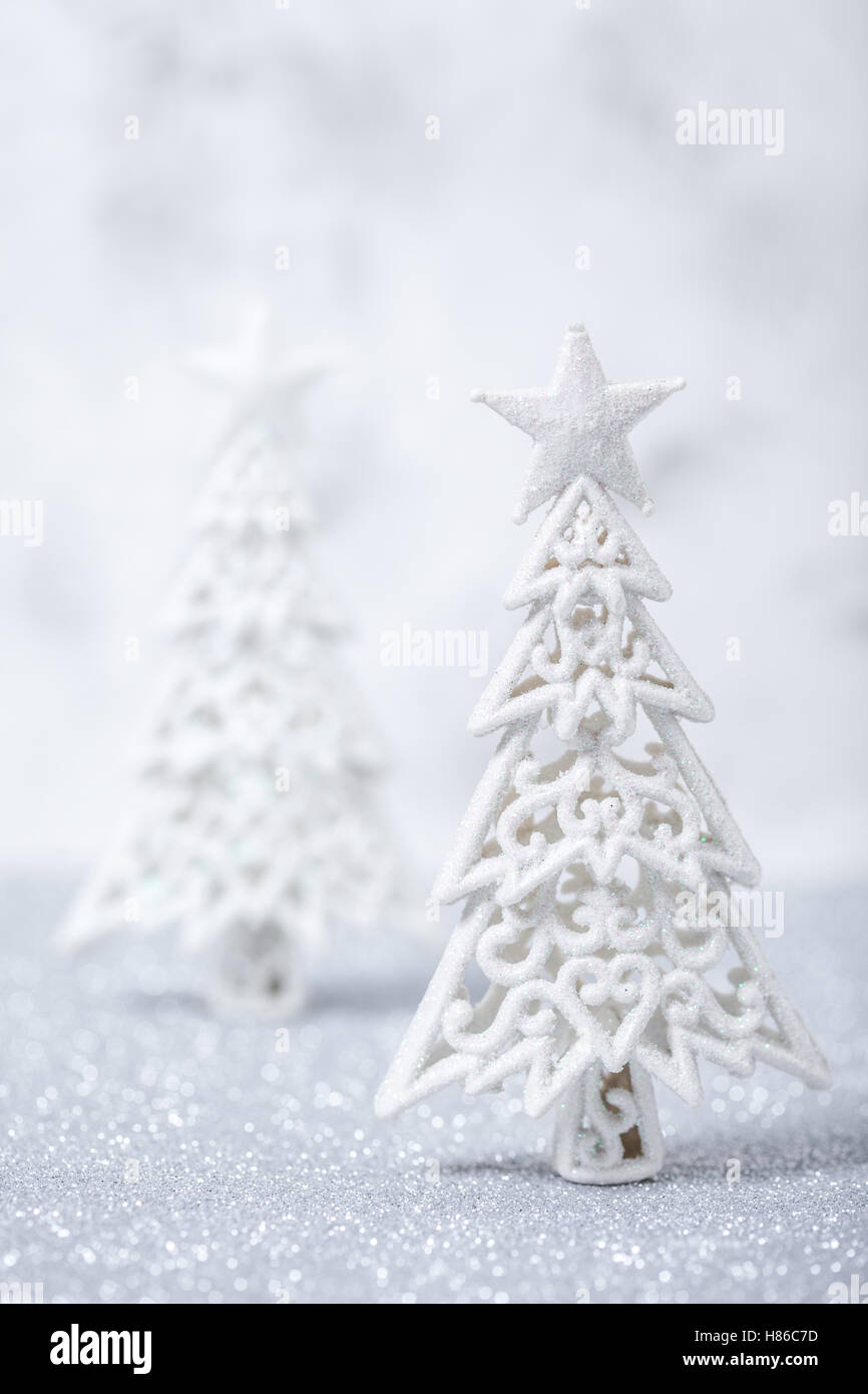 Sparkly glitter Christmas trees in silver and white Stock Photo - Alamy