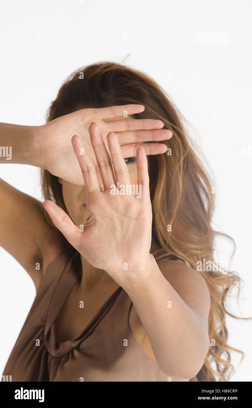 Scared woman hiding face with hands Stock Photo - Alamy