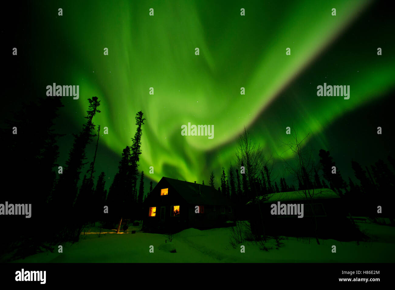 Aurora borealis over house, Alaska Stock Photo - Alamy