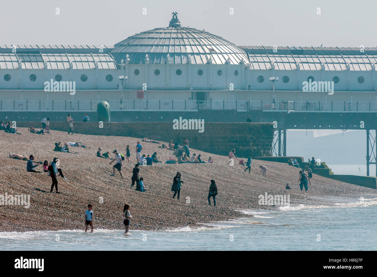 People enjoying the spring weather on Brighton beach Stock Photo - Alamy