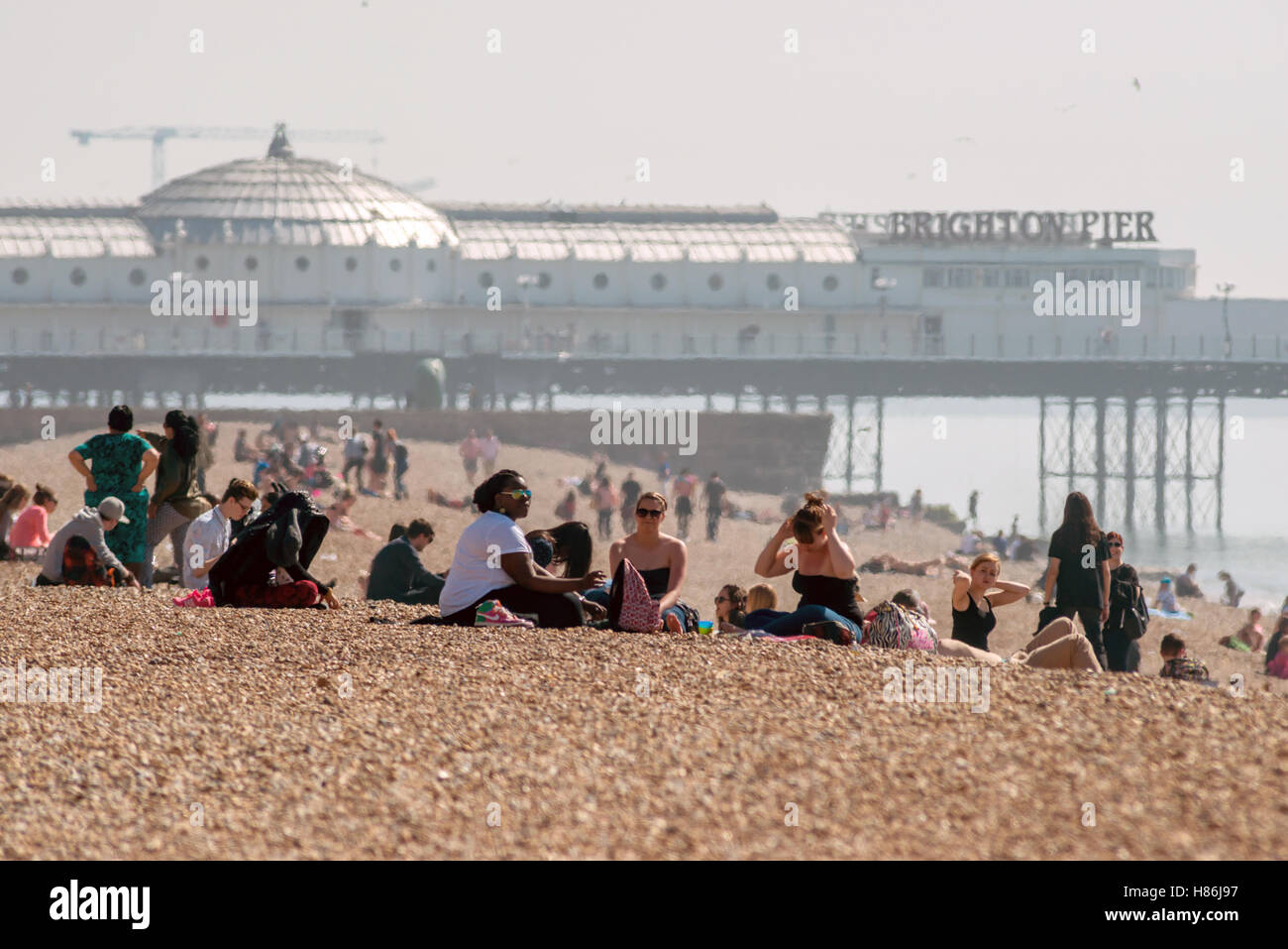 People enjoying the spring weather on Brighton beach Stock Photo - Alamy