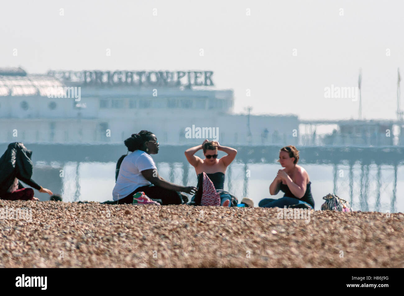People enjoying the spring weather on Brighton beach Stock Photo - Alamy