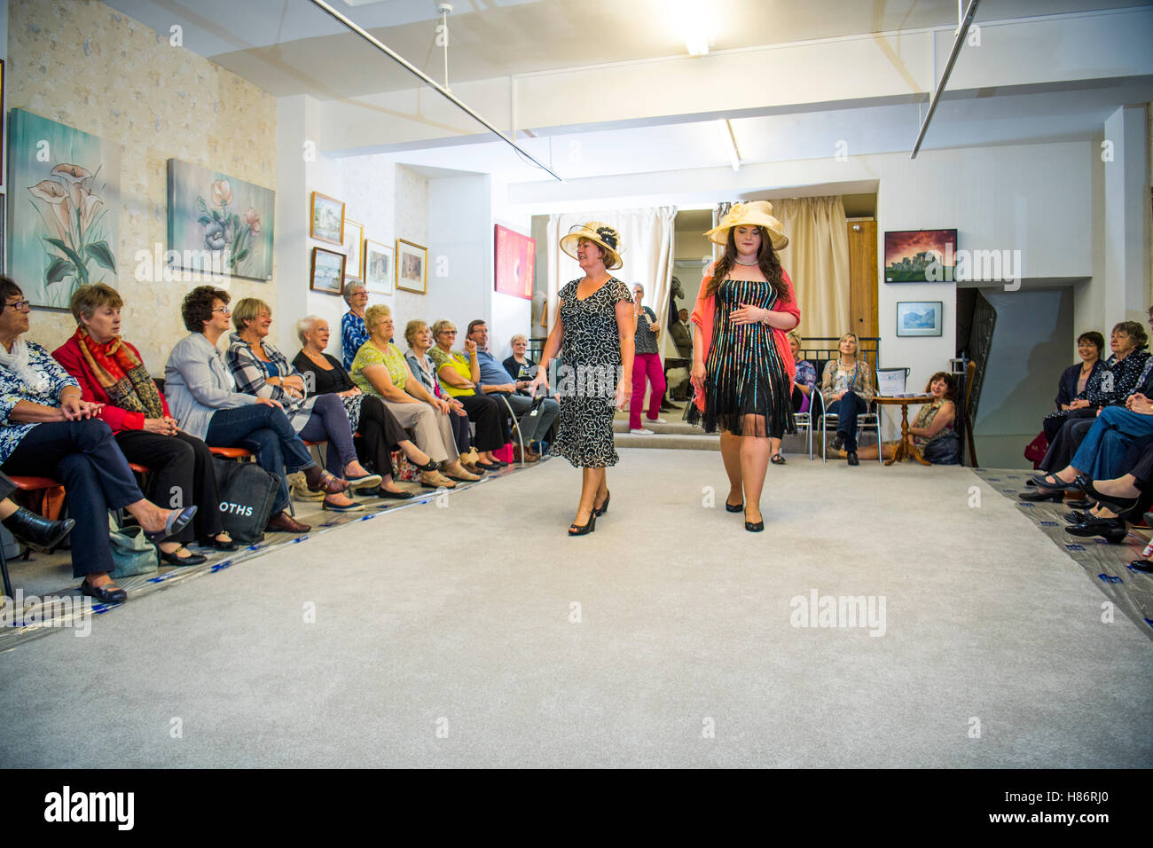 Volunteer models showing off clothes at a charity catwalk fashion show ...