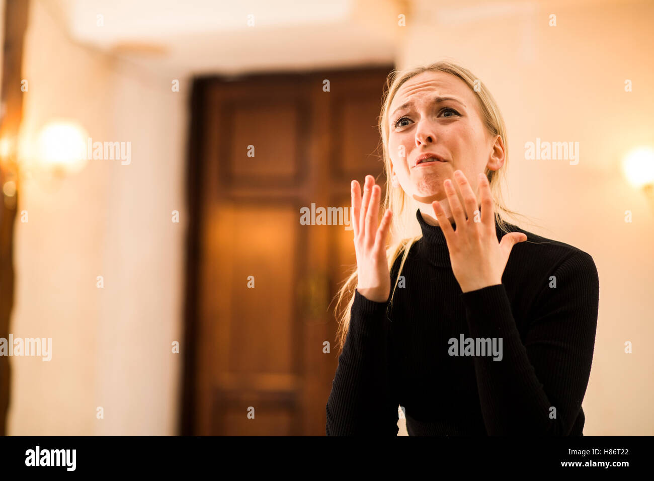 A Young woman actor wearing plain black costumes performing solo ...