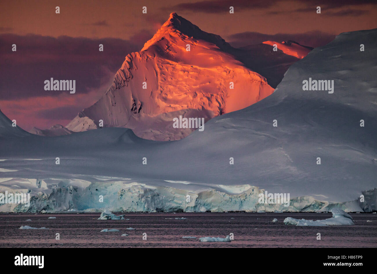 Alpenglow lighting up high peaks of Wiencke and Anvers Islands, near ...