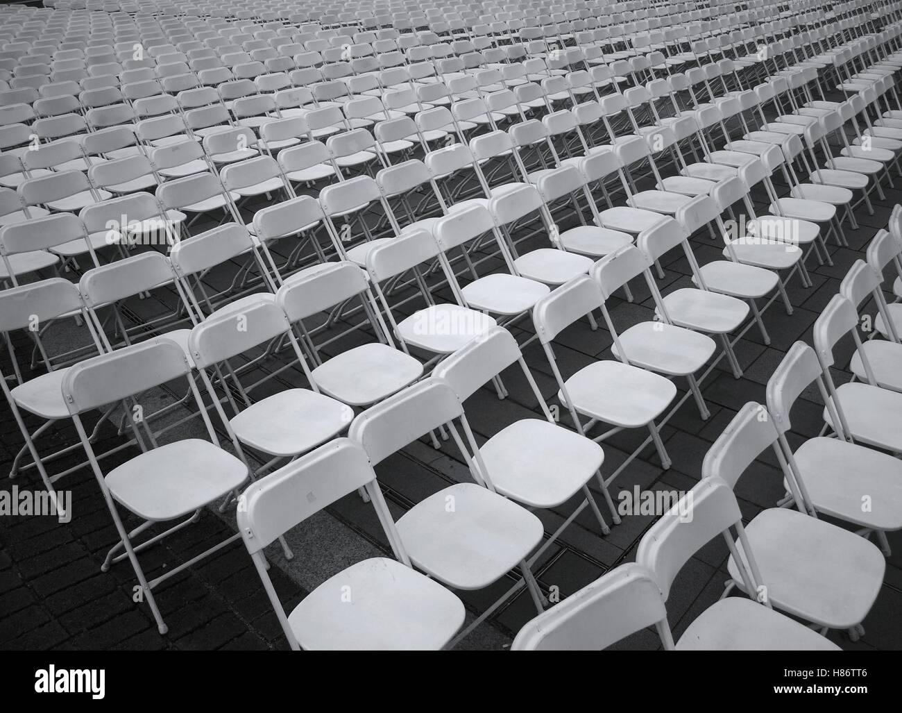 Row after row of plastic chairs are set up for an outdoor concert Stock ...