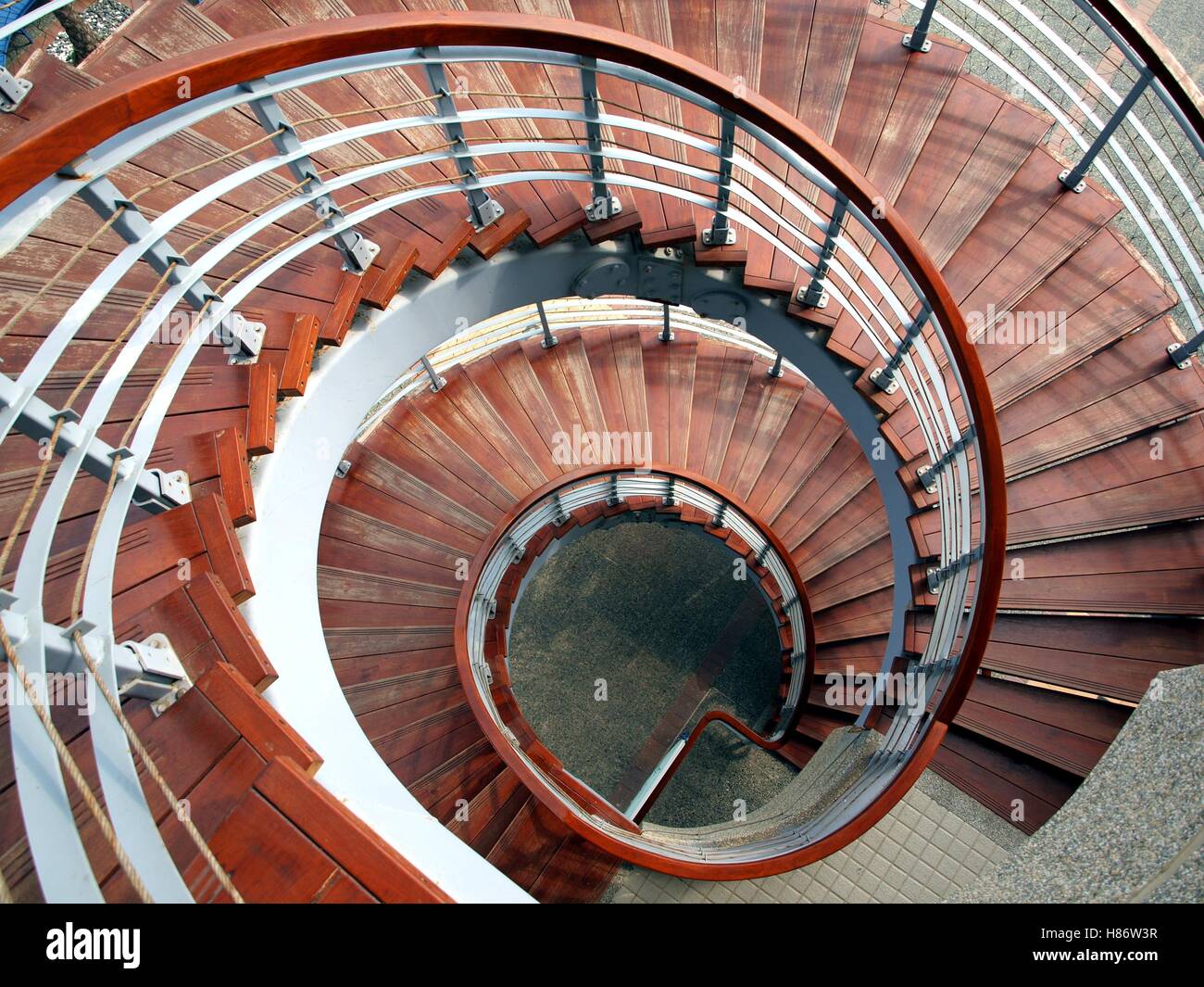 A winding staircase with steps made from wood Stock Photo - Alamy